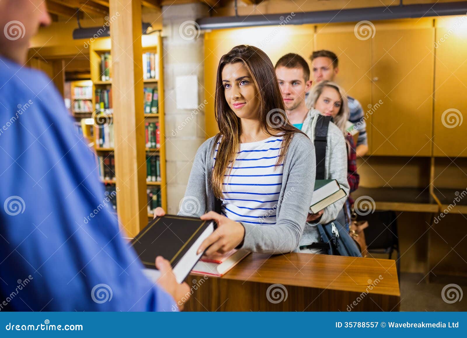 Young Students in a Row at the Library Counter Stock Image - Image of ...