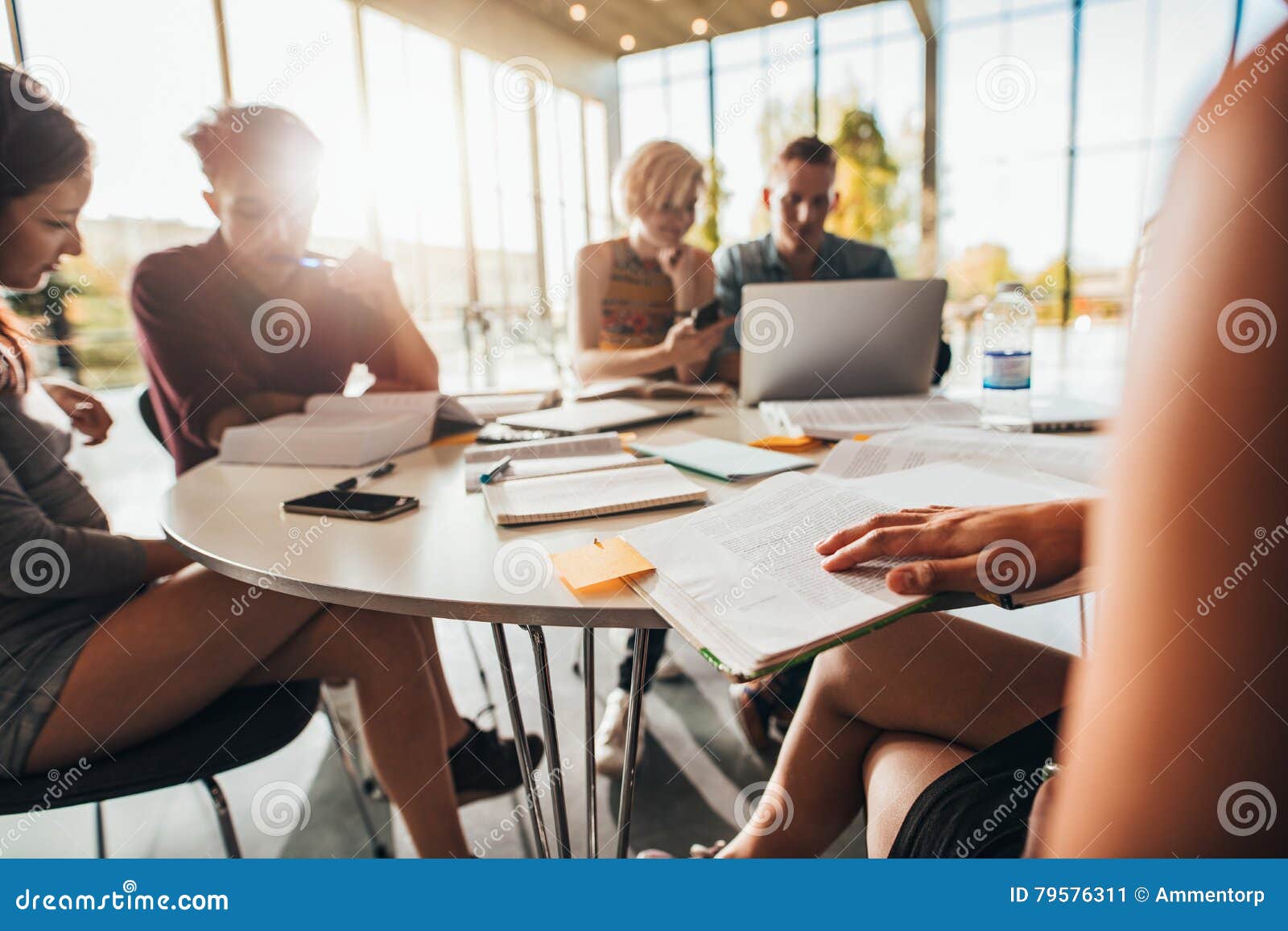 Young Students Sitting Around a Table in Library Stock Image - Image of ...