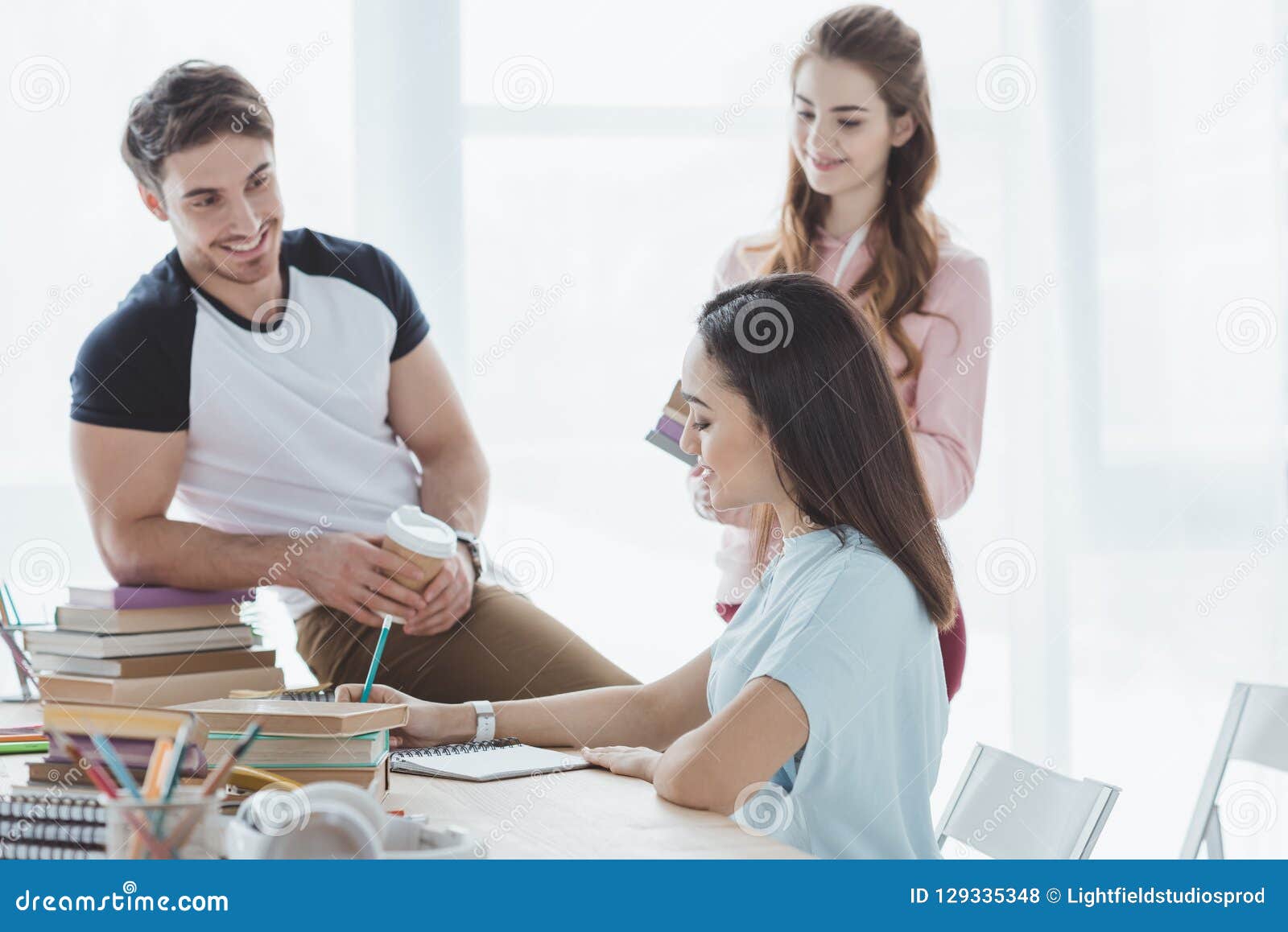 Young Students Sitting at Table and Studying Stock Photo - Image of ...