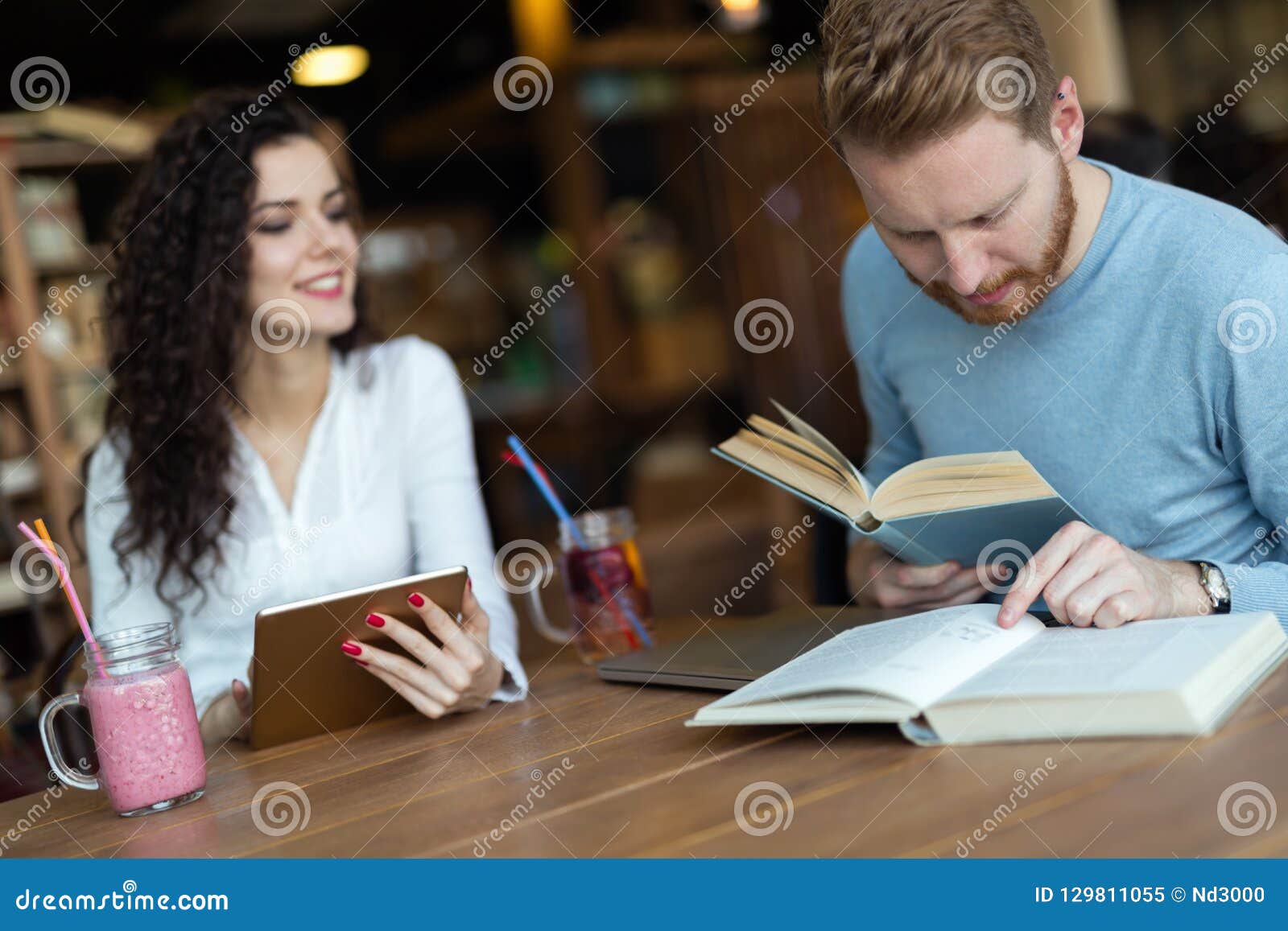 Young Students Spending Time in Coffee Shop Reading Books Stock Image ...