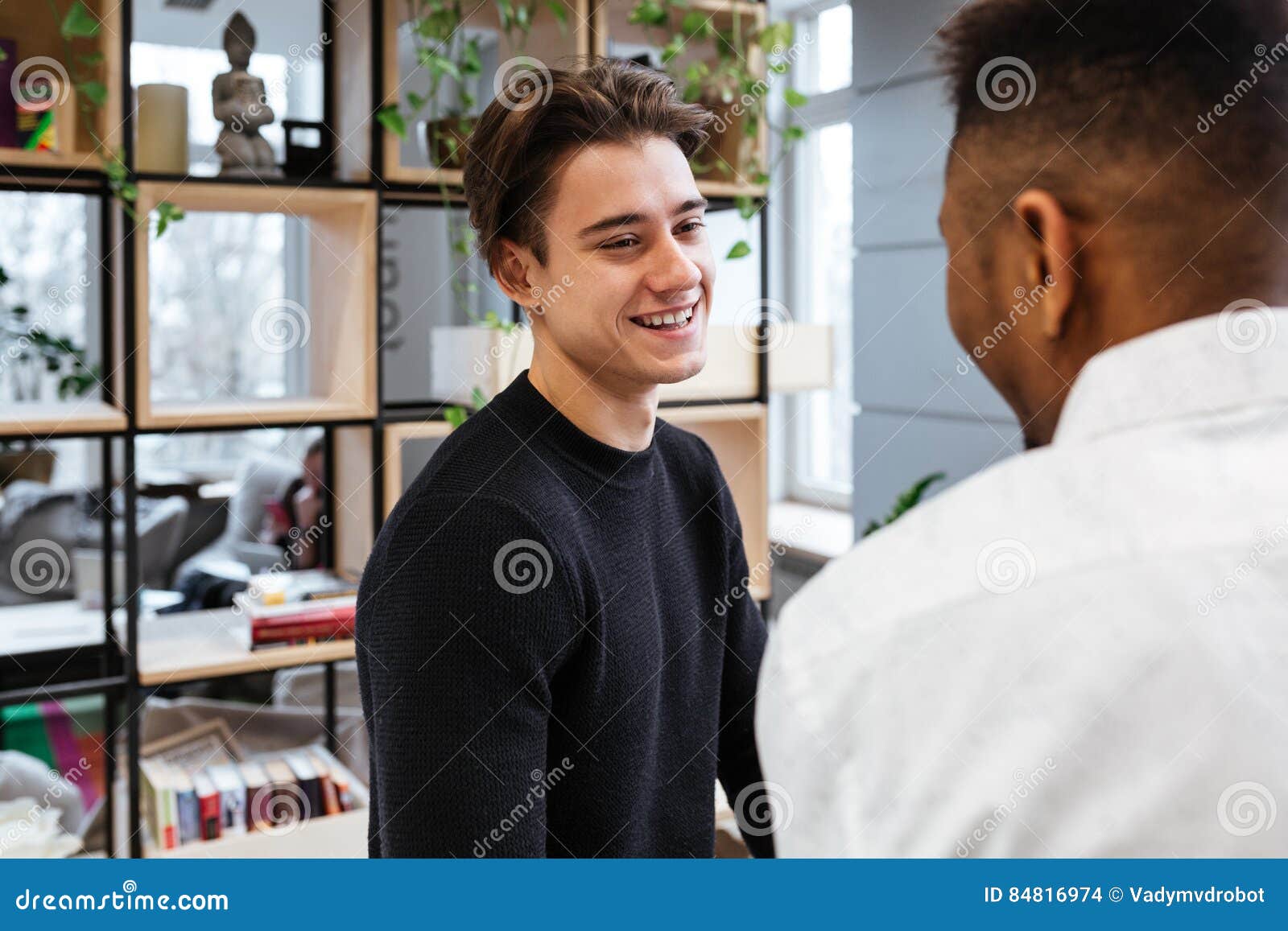 Young Students Standing in Library and Talking. Stock Photo - Image of ...