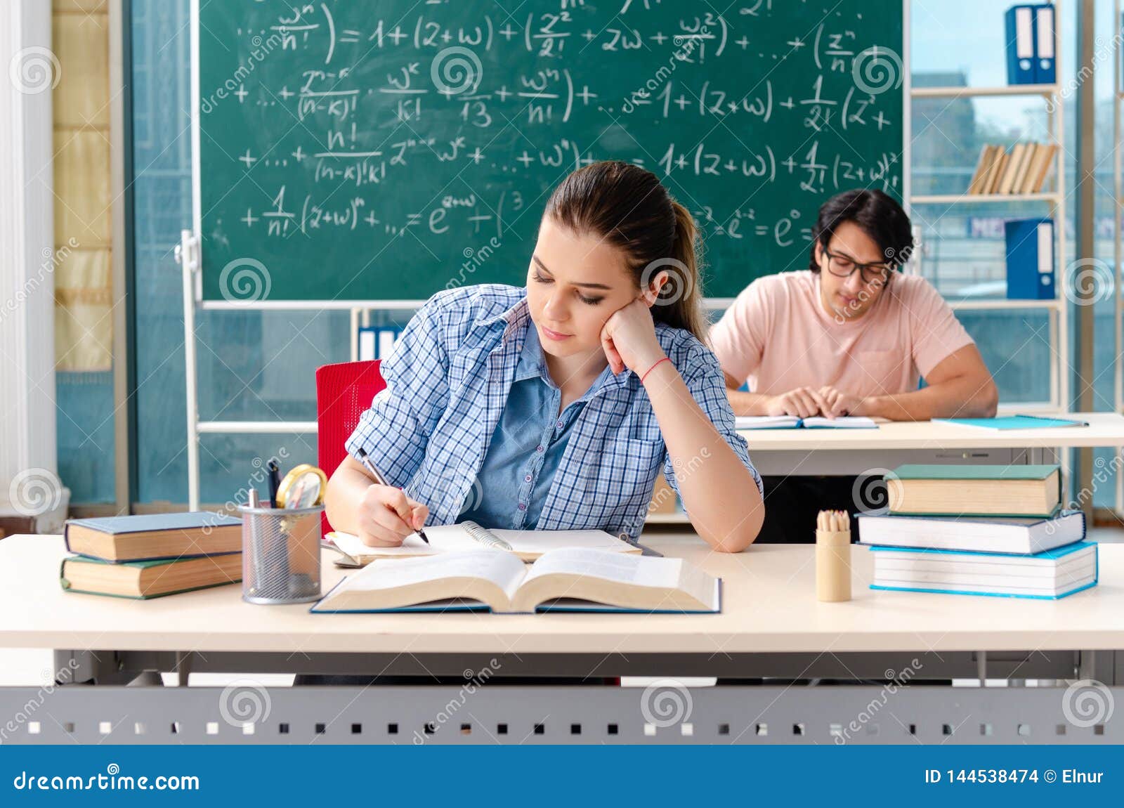 The Young Students Taking the Math Exam in Classroom Stock Photo ...