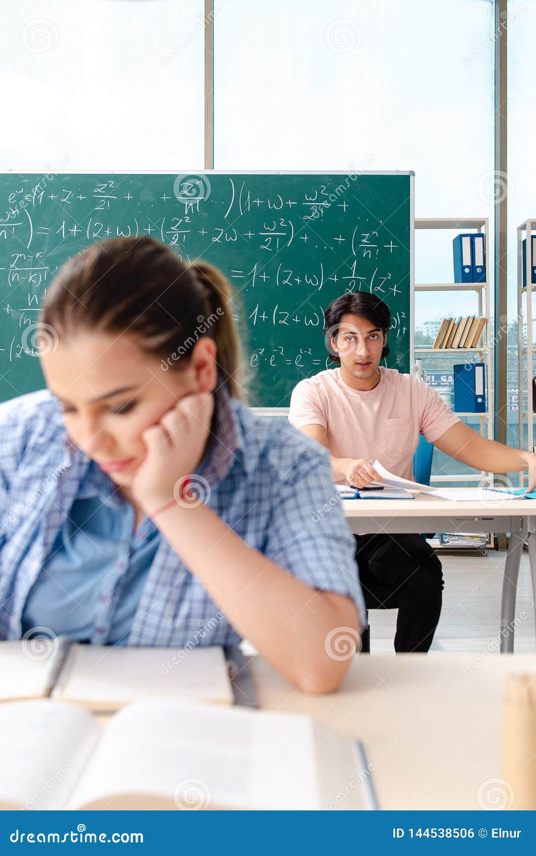 The Young Students Taking the Math Exam in Classroom Stock Photo ...