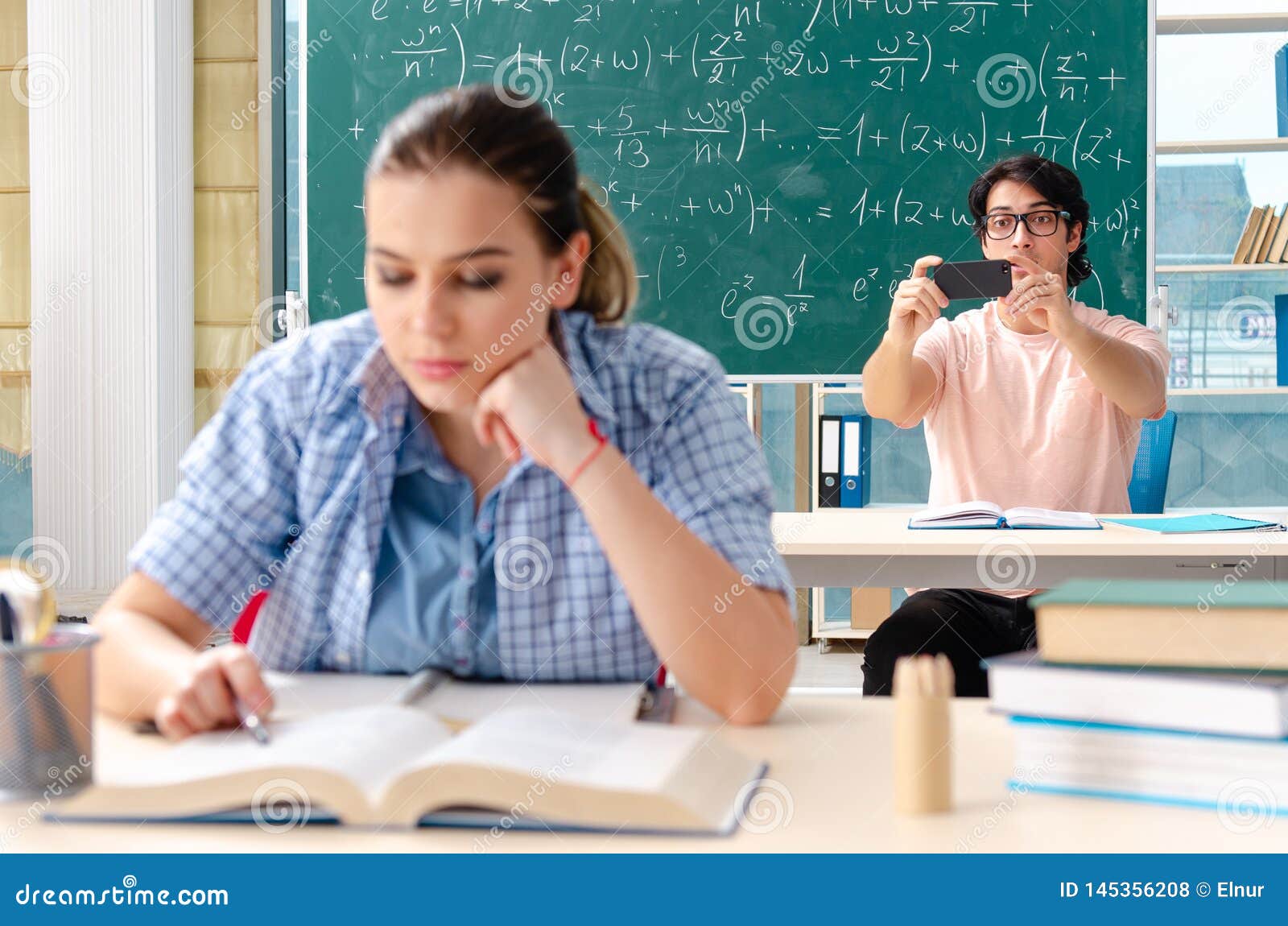 The Young Students Taking the Math Exam in Classroom Stock Photo ...