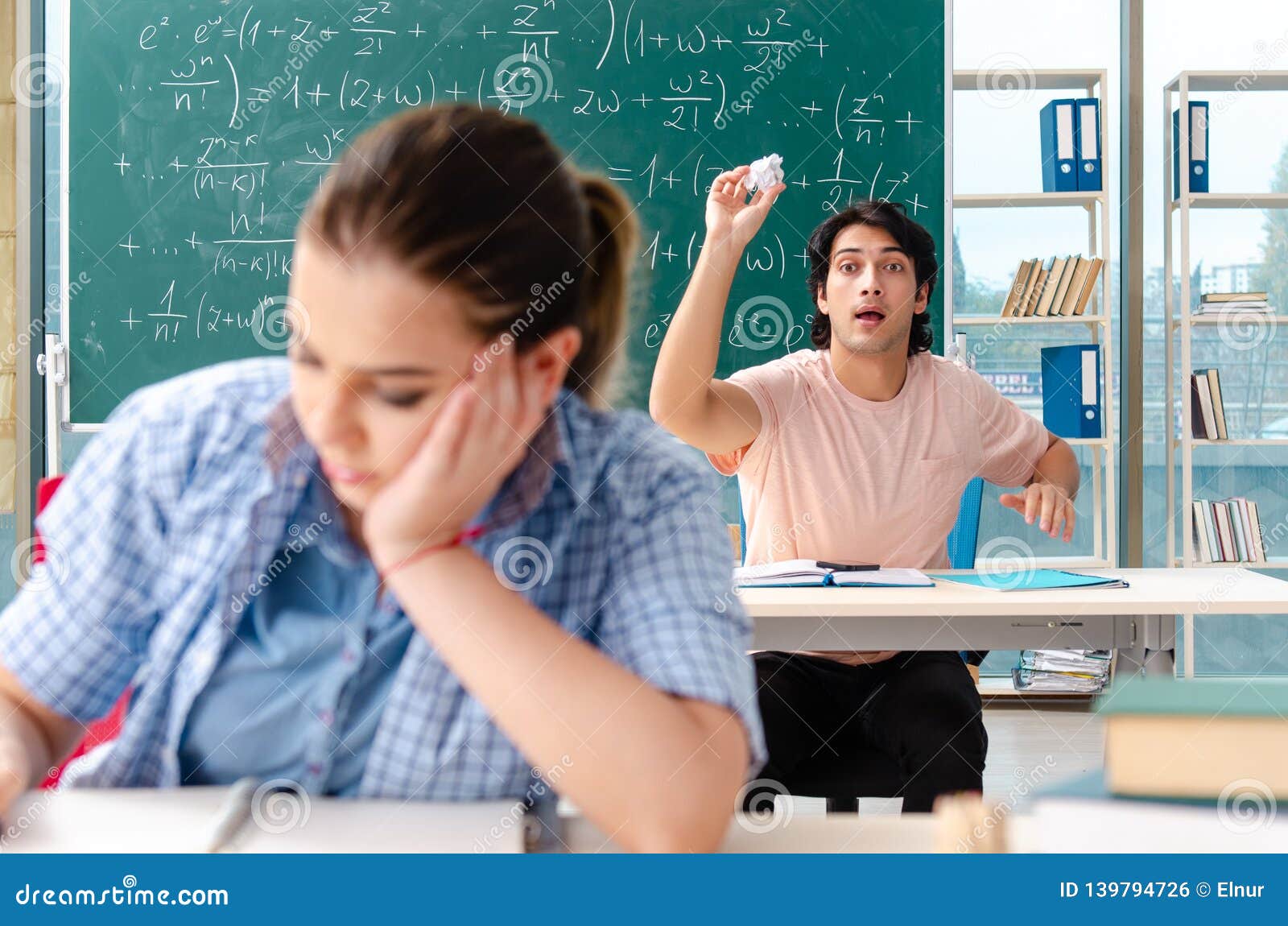 The Young Students Taking the Math Exam in Classroom Stock Photo ...