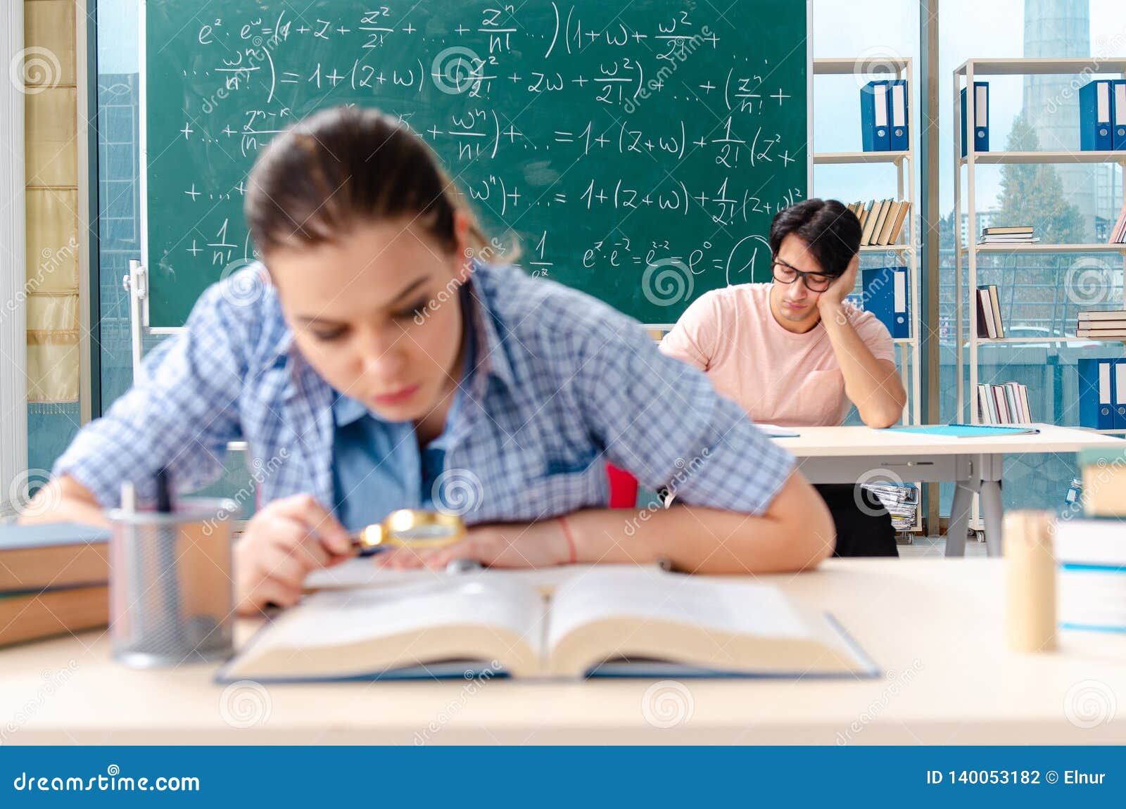 The Young Students Taking the Math Exam in Classroom Stock Photo ...