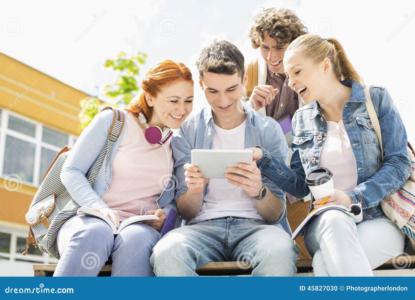 Young Students Using Digital Tablet at College Campus Stock Photo ...