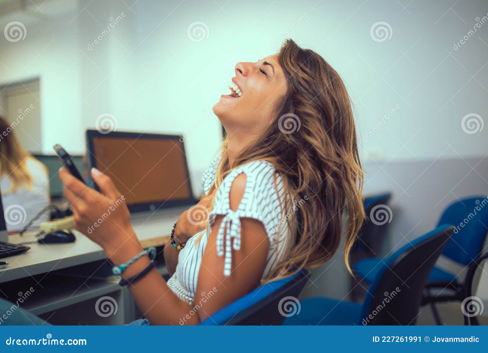 Young Students Using Phone in a Computer Lab Stock Image - Image of ...