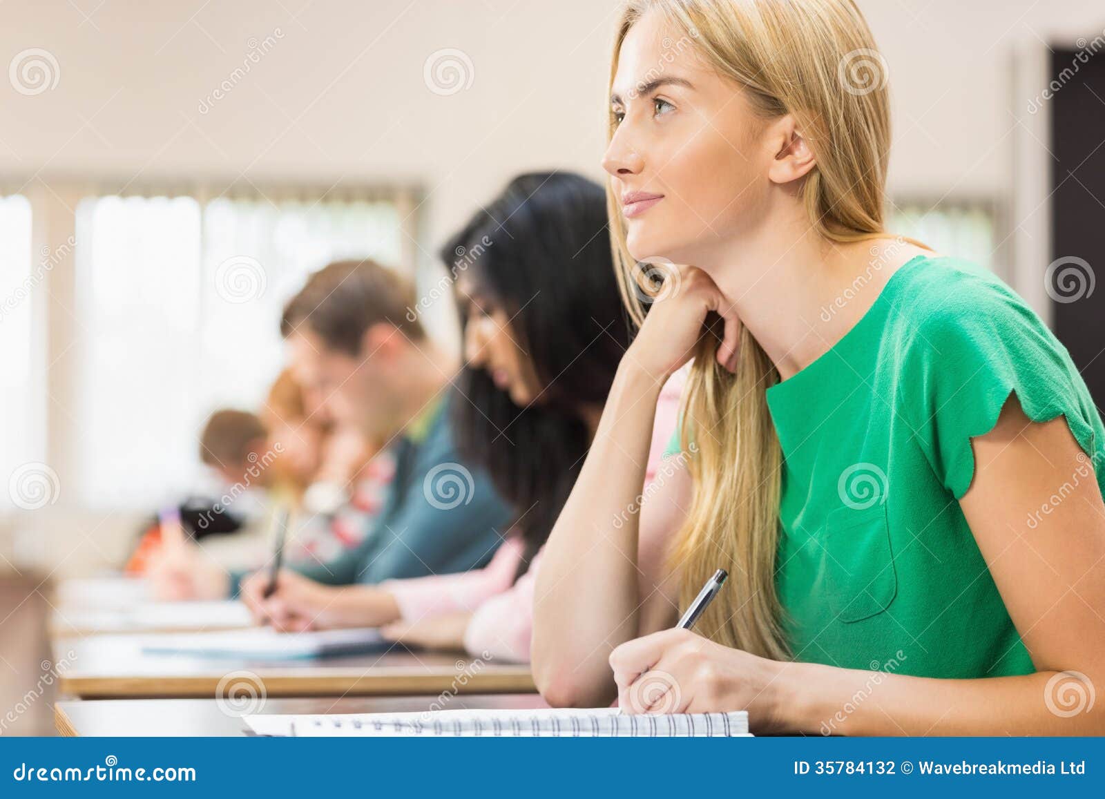 Young Students Writing Notes in Classroom Stock Photo - Image of ...