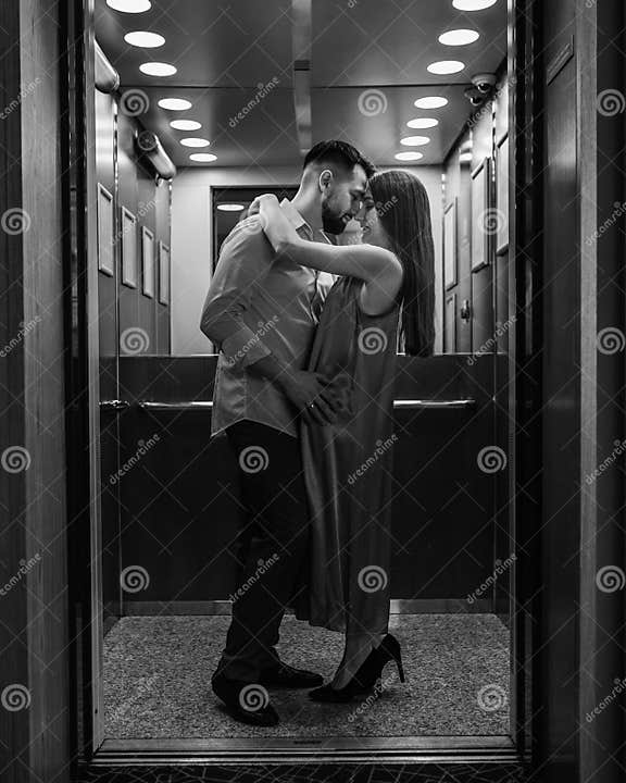 Young Stylish Caucasian Couple Hugging And Kissing In Hotels Elevator