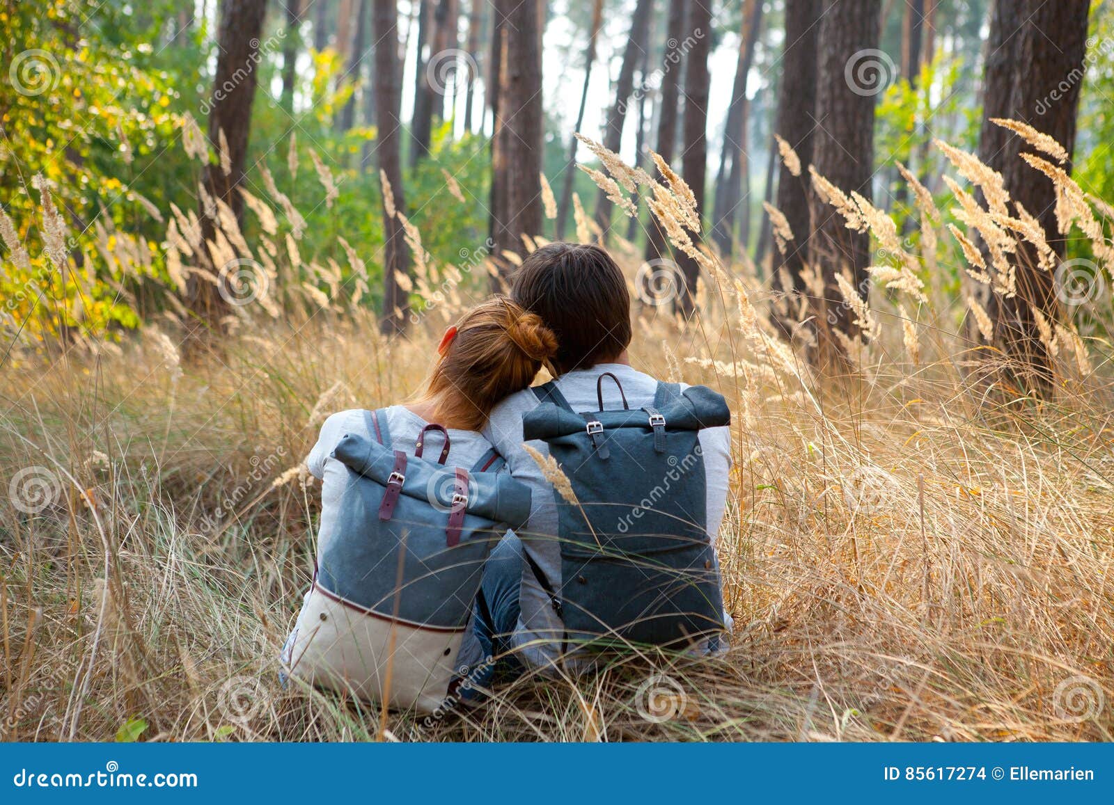 Young Stylish Couple with Backpacks Hugging in Forest Stock Photo ...