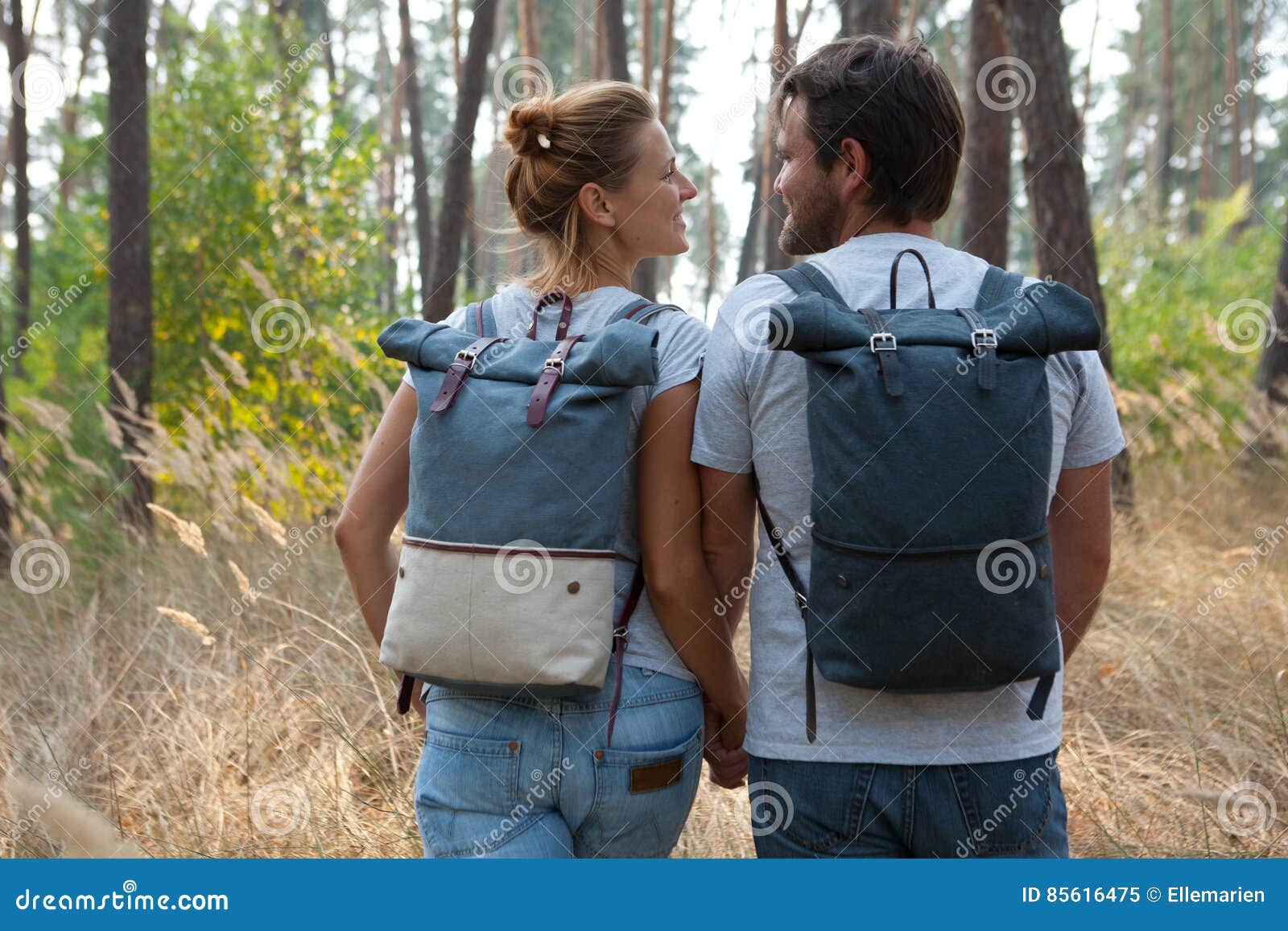 Young Stylish Couple with Backpacks Hugging in Forest Stock Image ...