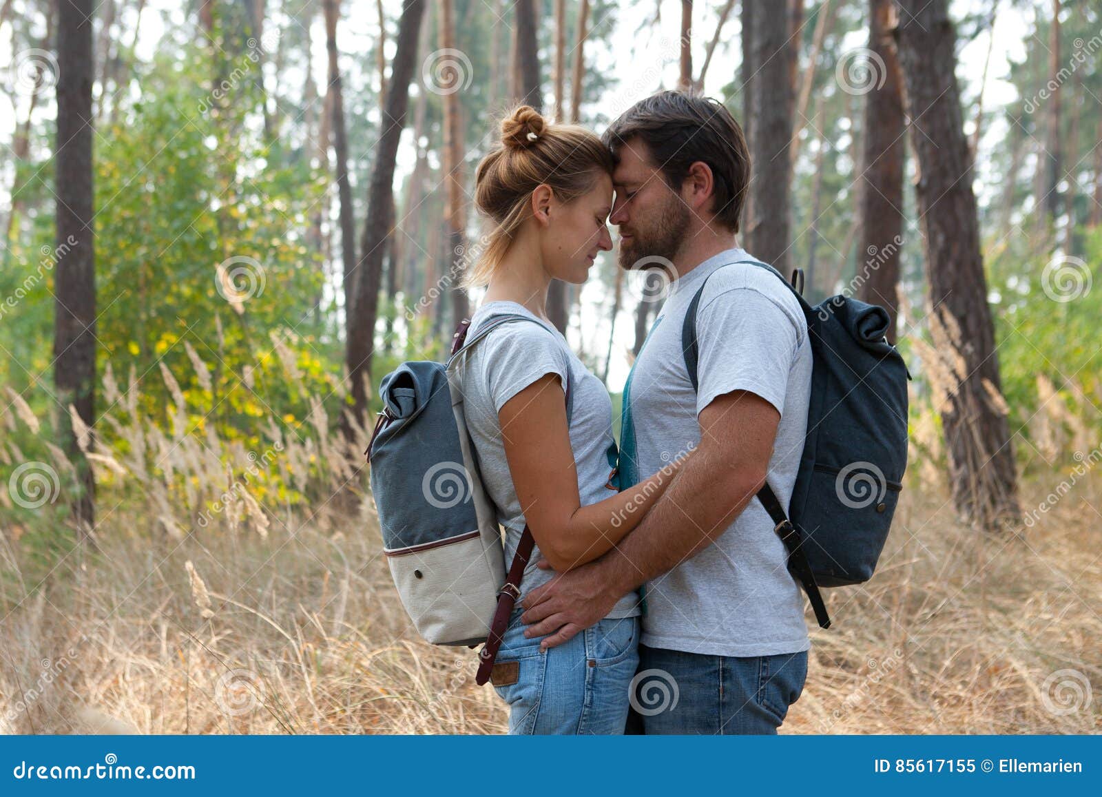Young Stylish Couple with Backpacks Hugging in Forest Stock Image ...