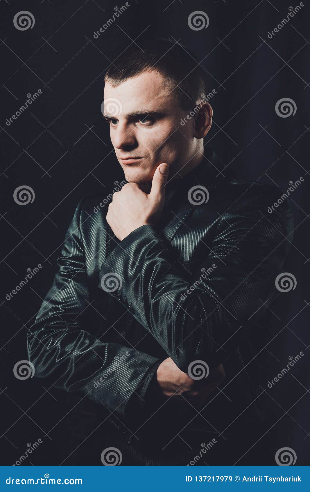 Young Stylish Guy Dressed In Black Classic Suit On A Black Background ... Young Stylish Guy Dressed In Black Classic Suit On A Black Background ...