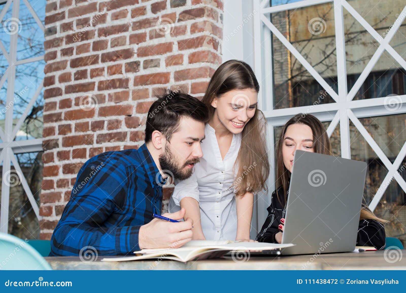 Young Successful Business Partner Using Laptop Computer and Cell Phone ...