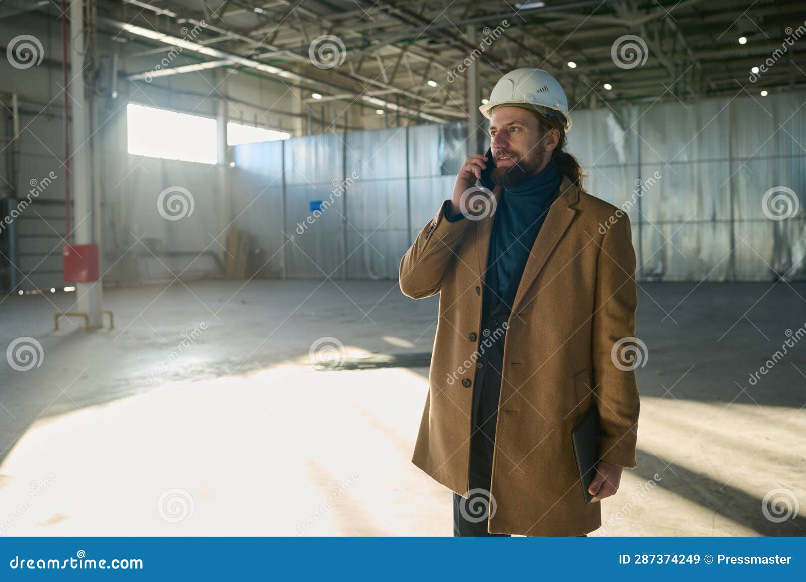 Young Successful Engineer in Casualwear and Hardhat Talking on Mobile ...
