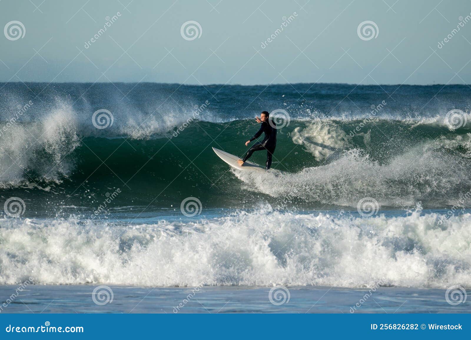 Young Surfer Catching Waves before Work on an Early Friday Morning at ...
