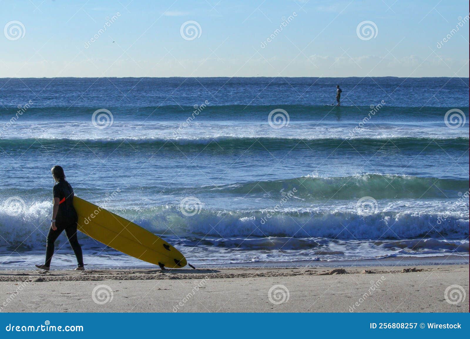 Young Surfer Walking Along the Beach with a Big Yellow Surfboard ...