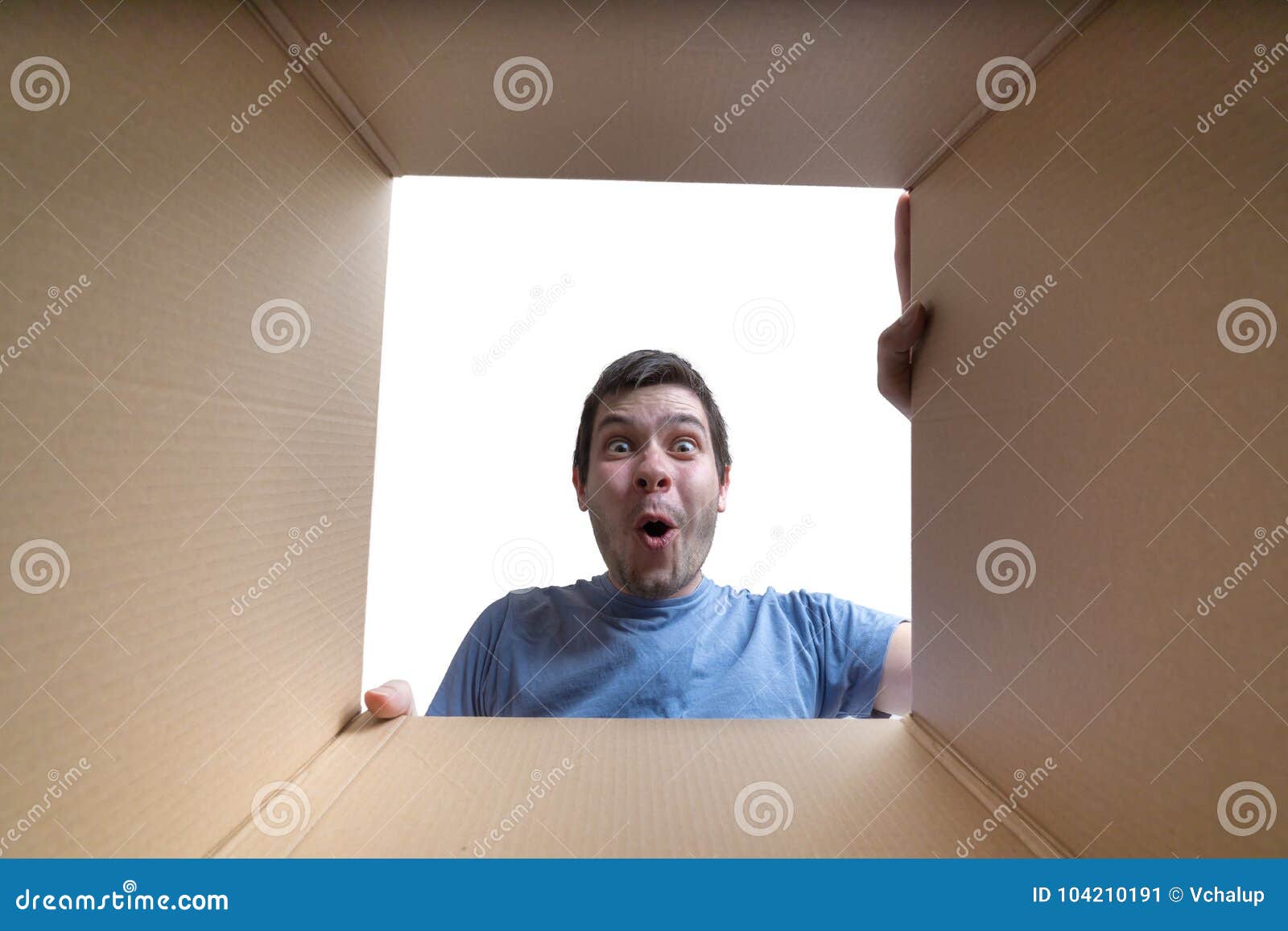 Young Surprised Man is Looking Inside Cardboard Box Stock Image - Image ...