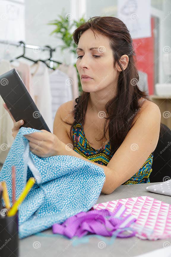 Young Tailor Looking at Tablet Stock Image - Image of internet, thread ...