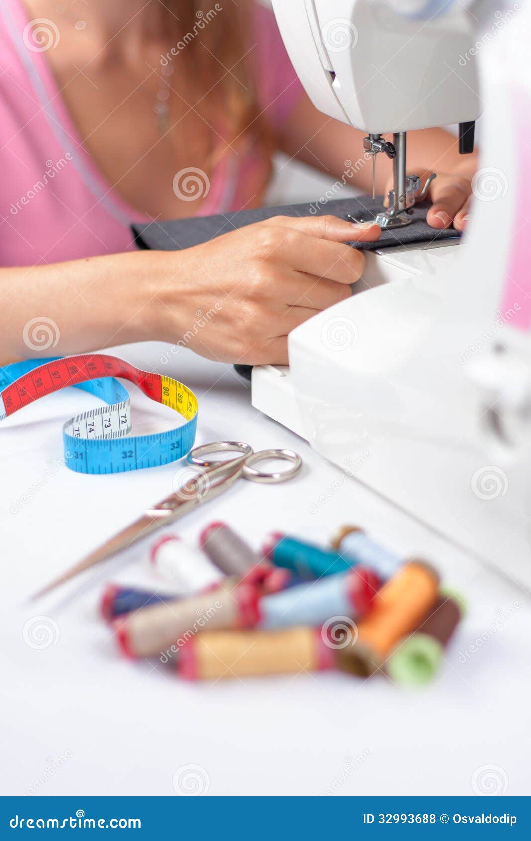 Young Tailor Sews a Pair of Trousers, Vertical Stock Photo - Image of ...