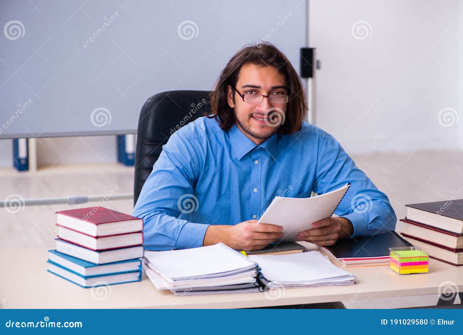 Young Male Teacher in the Classroom Stock Photo - Image of discussing ...