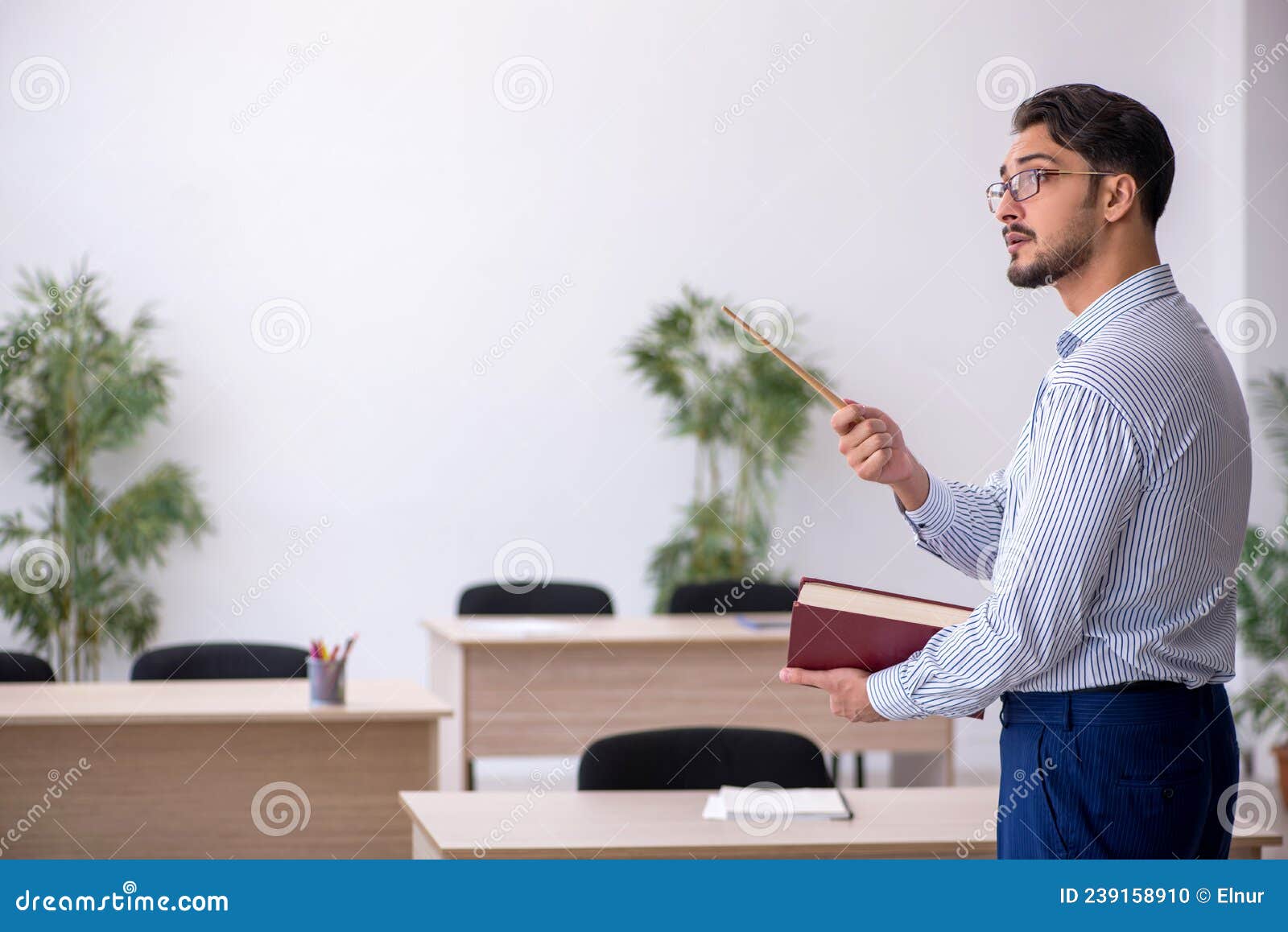 Young Male Teacher in the Classroom Stock Photo - Image of tutoring ...