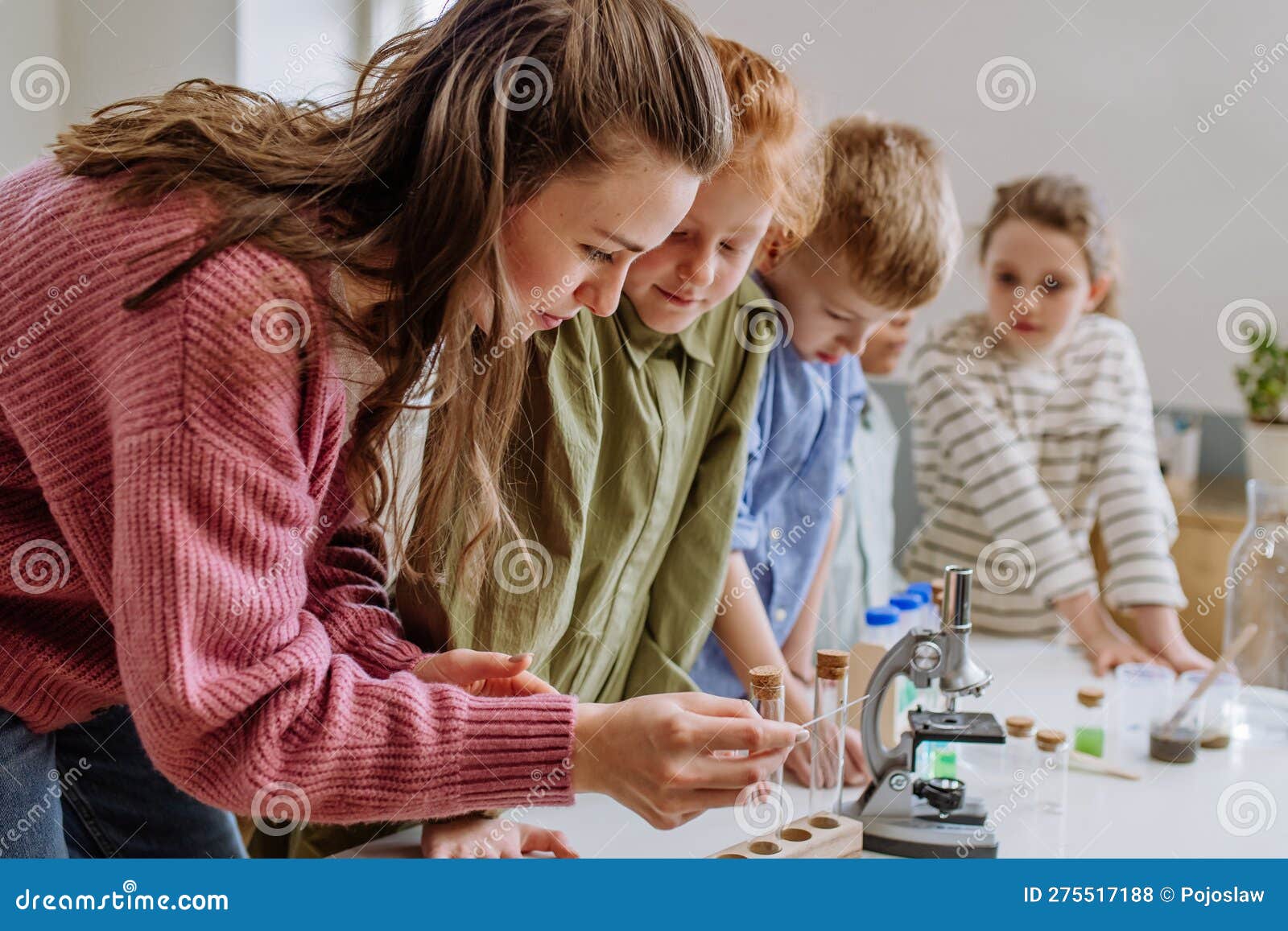 Young Teacher Doing Chemistry Experiment with Pupils during Science ...