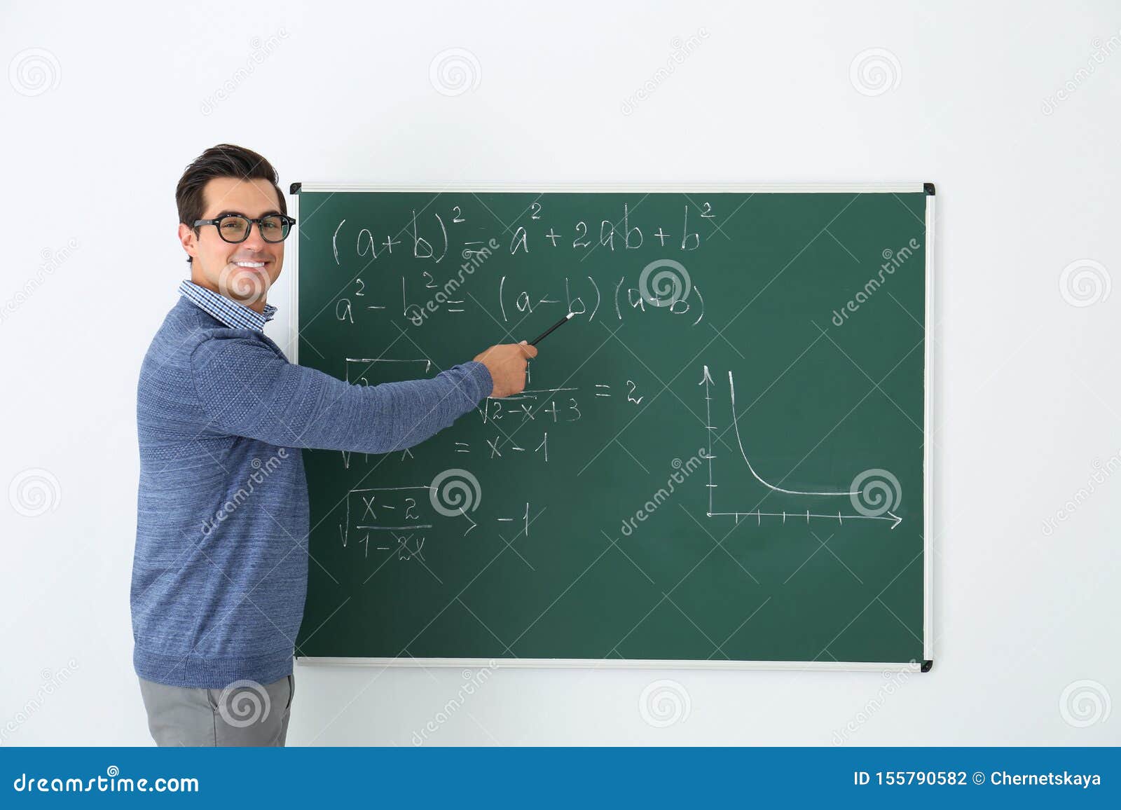 Young Teacher Explaining Math Written on Chalkboard in Classroom Stock ...