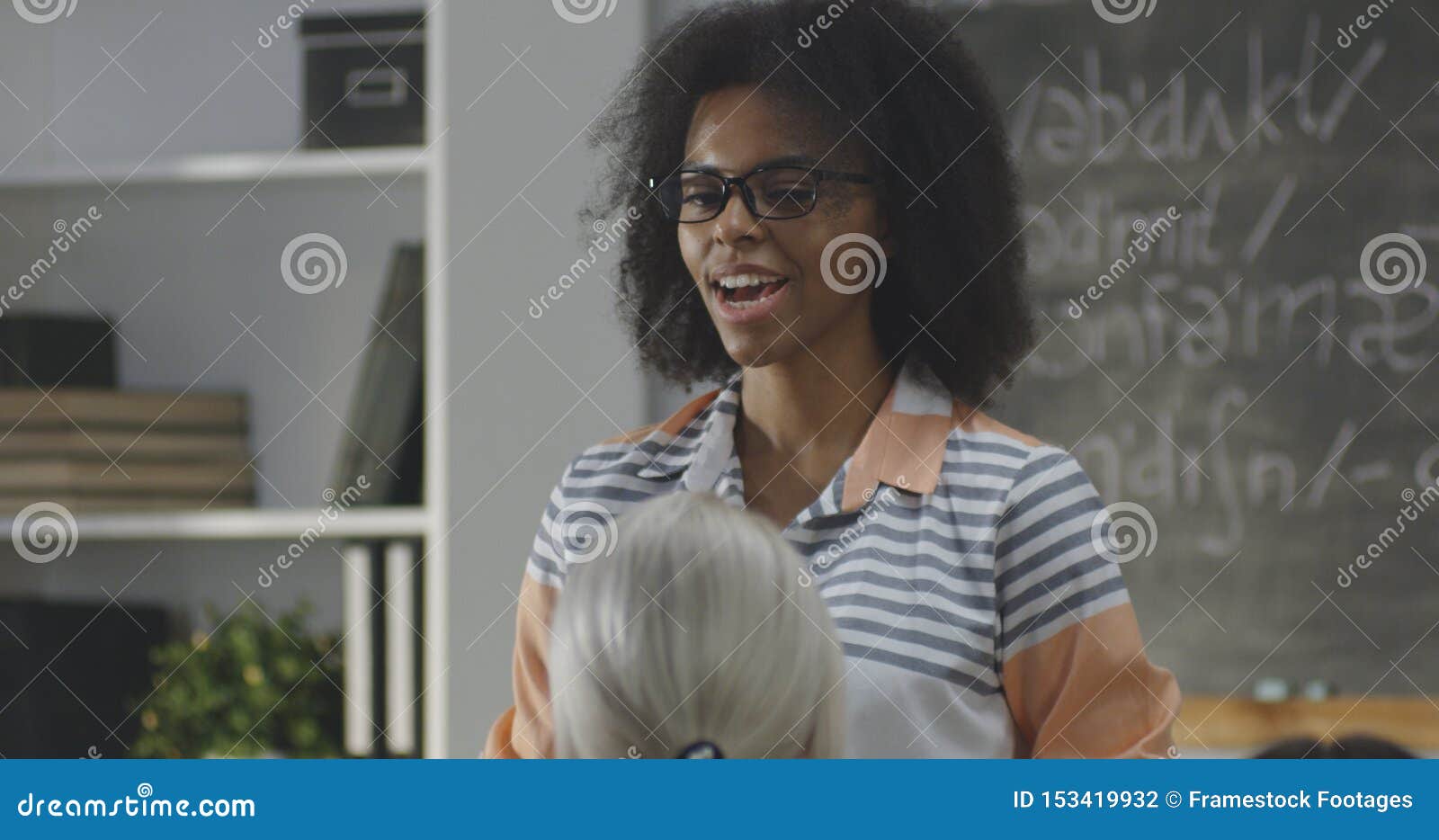 Young Teacher Explaining To a Class Stock Photo - Image of teaching ...