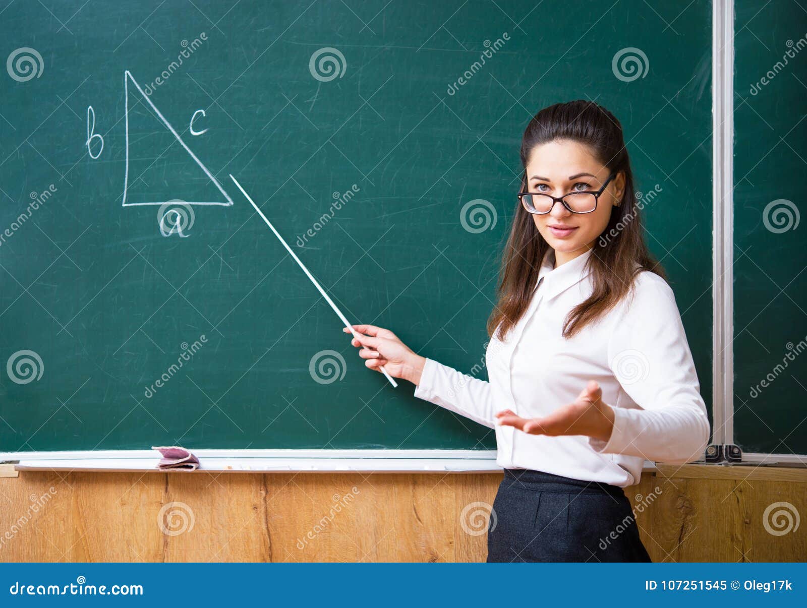 A Young Teacher Explains Math Near the Board Stock Image - Image of ...