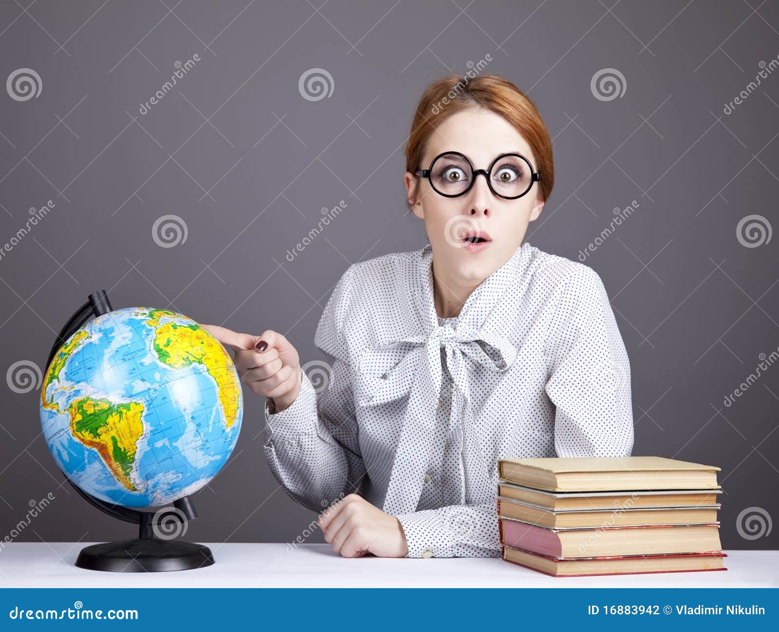 The Young Teacher in Glasses with Books and Globe Stock Photo - Image ...