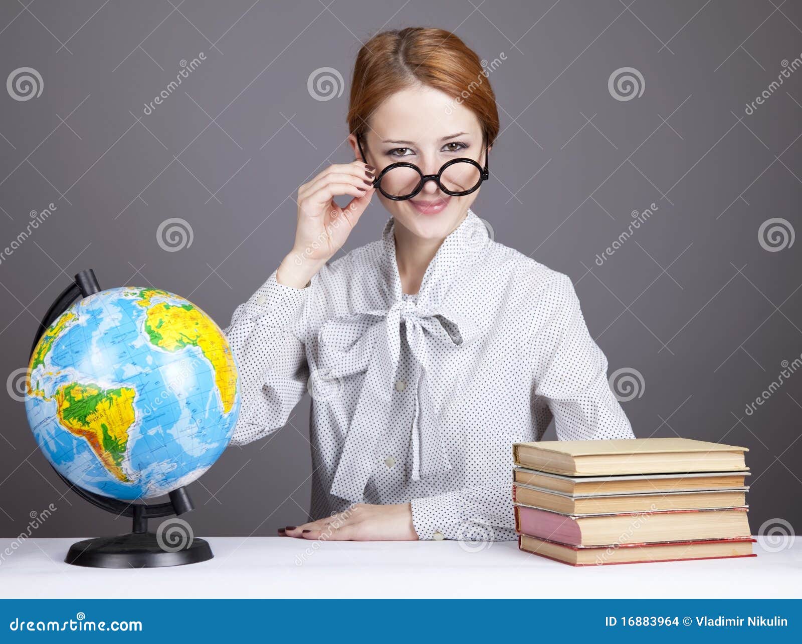 The Young Teacher in Glasses with Books and Globe Stock Photo - Image ...