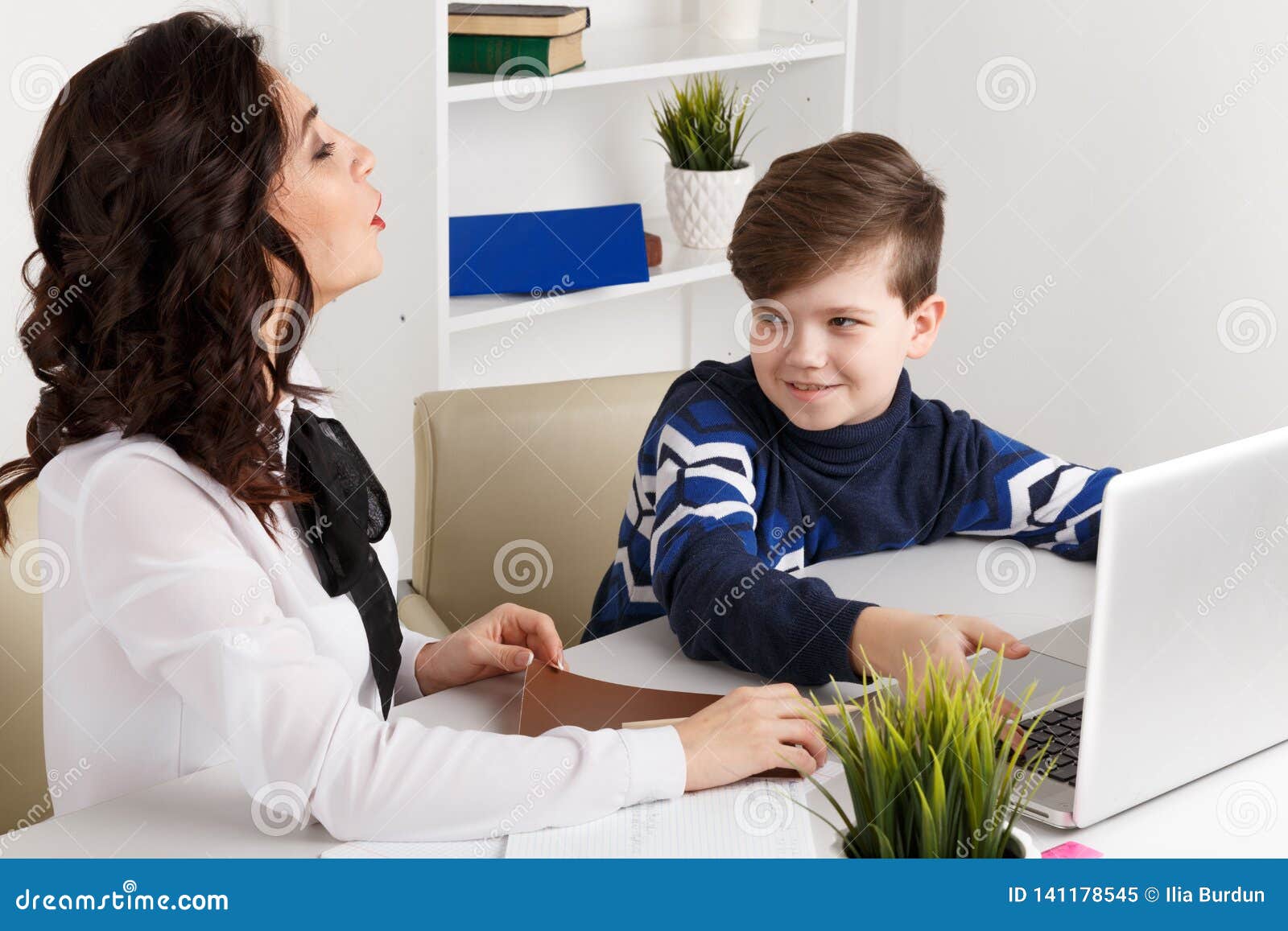 Young Teacher with Kid Doing Homework on a Computer. Tutor Help. Stock ...