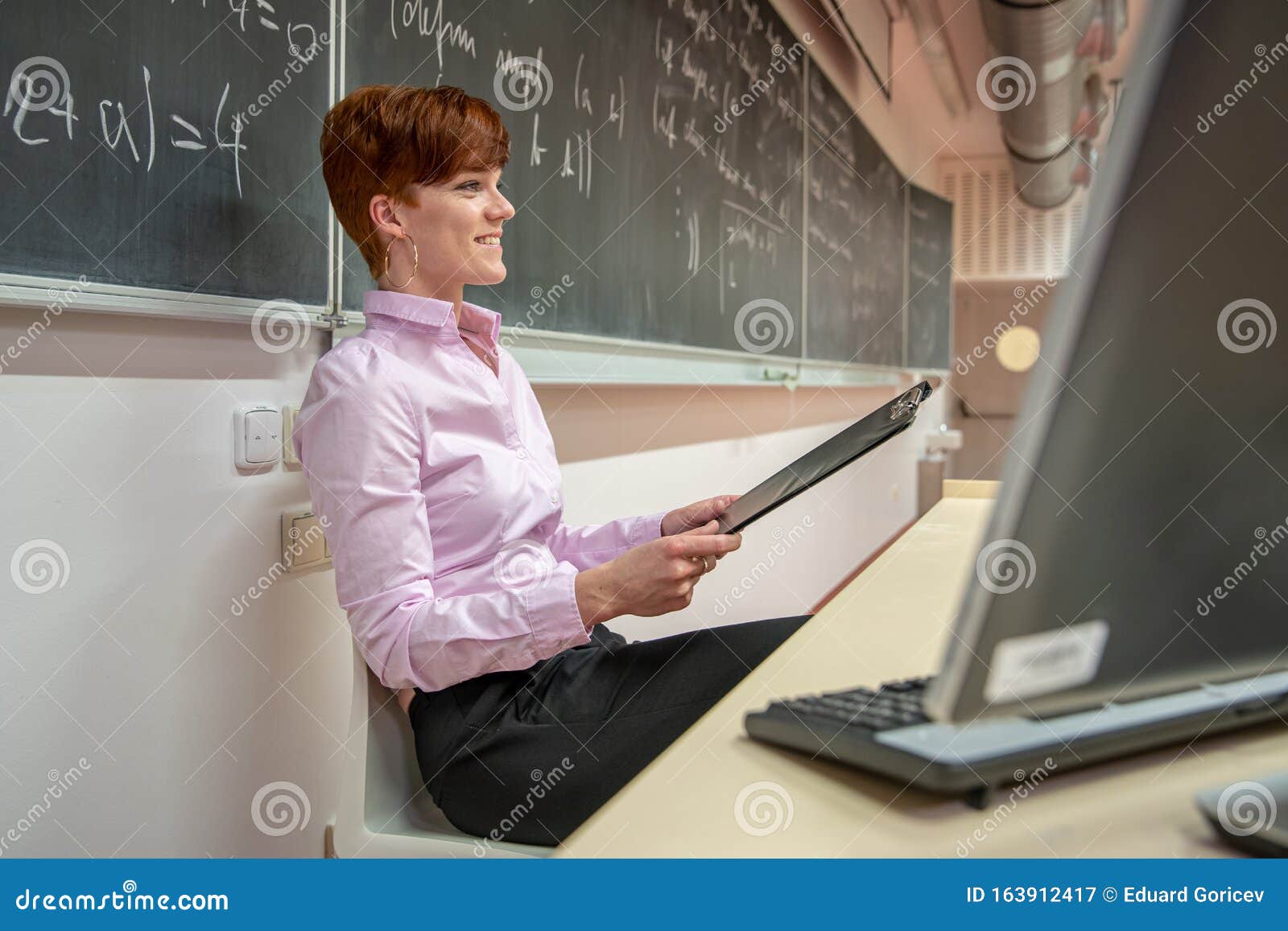Young Teacher Lectures at the School of Mathematics, Writes Chalk on a ...