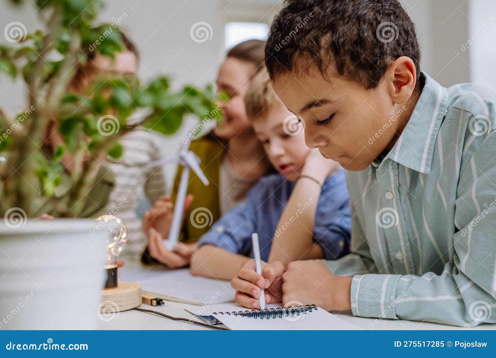 Young Teacher with Model of Wind Turbine Learning Pupils about Wind ...