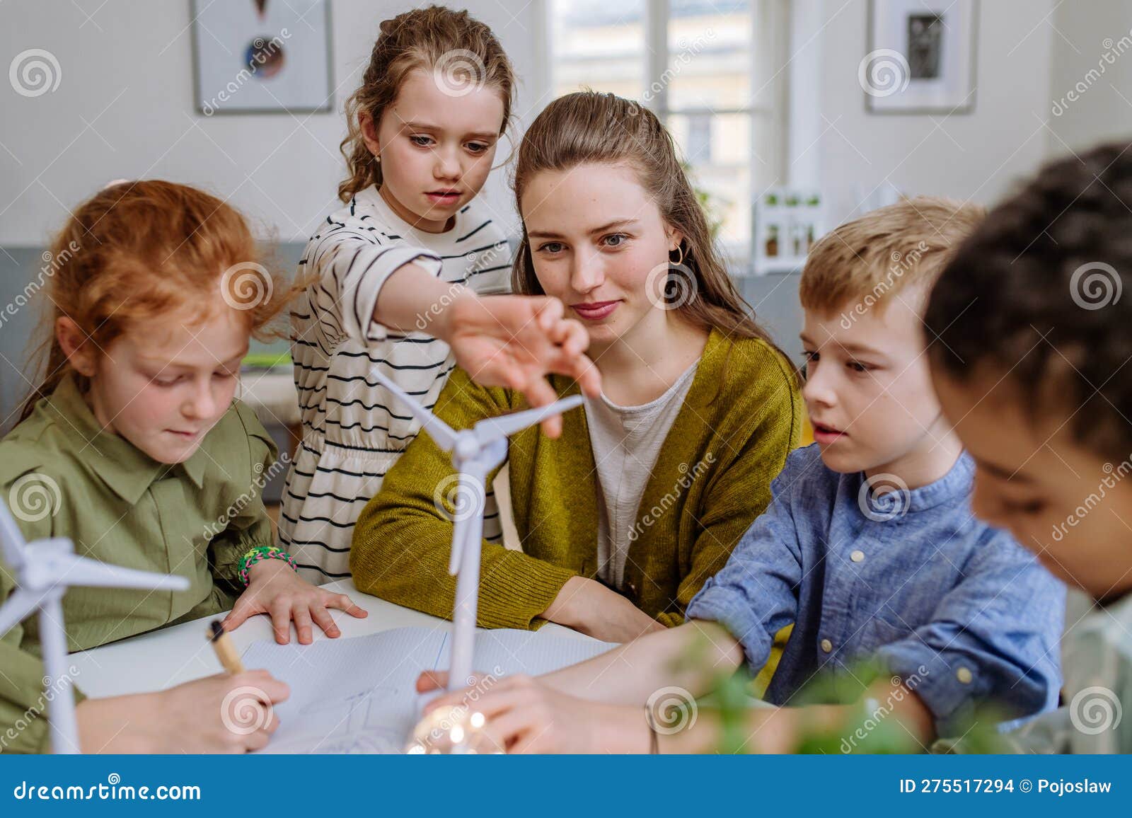 Young Teacher with Model of Wind Turbine Learning Pupils about Wind ...