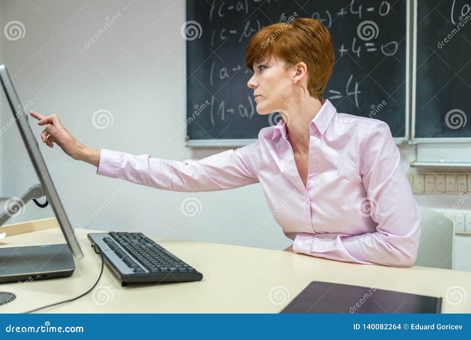 Young Woman Prepares a Teaching Lesson in Class on Her Computer Stock ...