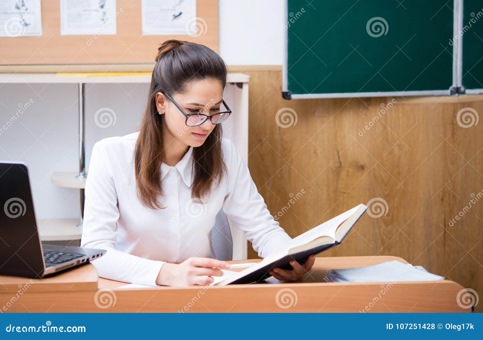 A Young Teacher Reading a Book Stock Photo - Image of teacher, college ...