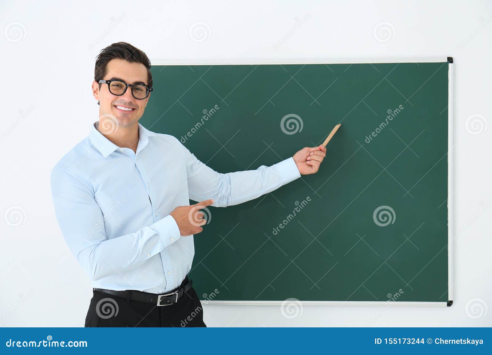 Young Teacher with Ruler Near Blank Chalkboard in . Space for Text ...