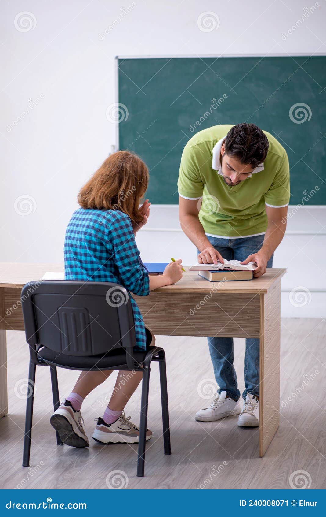 Young Teacher and Student in the Classroom Stock Image - Image of ...