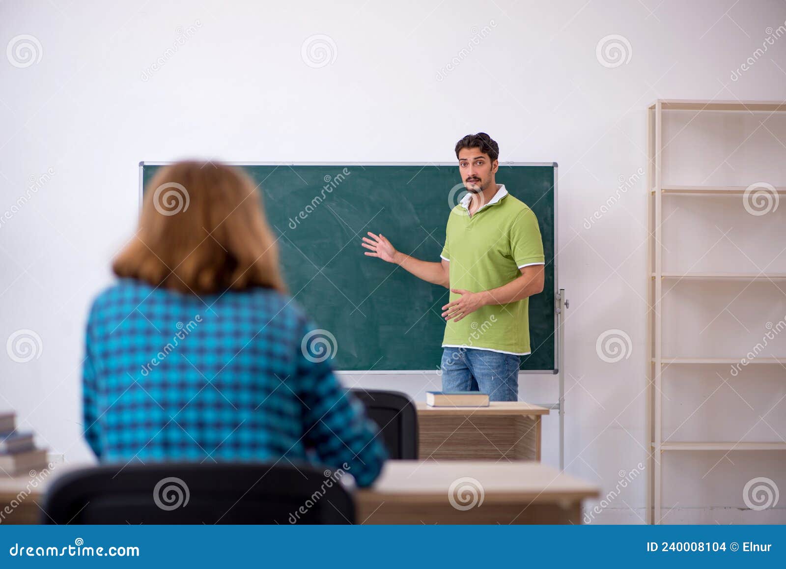 Young Teacher and Student in the Classroom Stock Photo - Image of ...