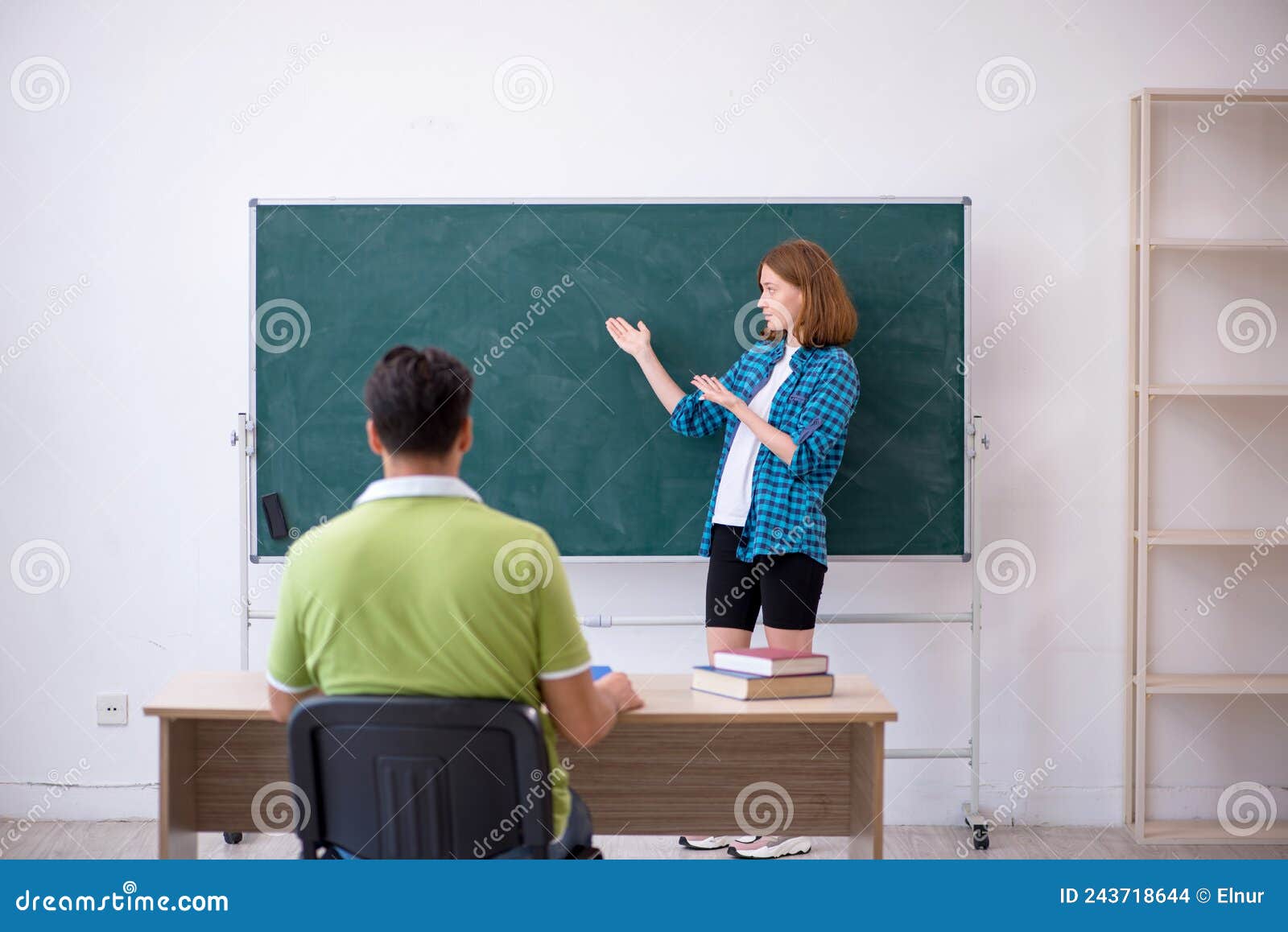 Young Teacher and Student in the Classroom Stock Photo - Image of ...
