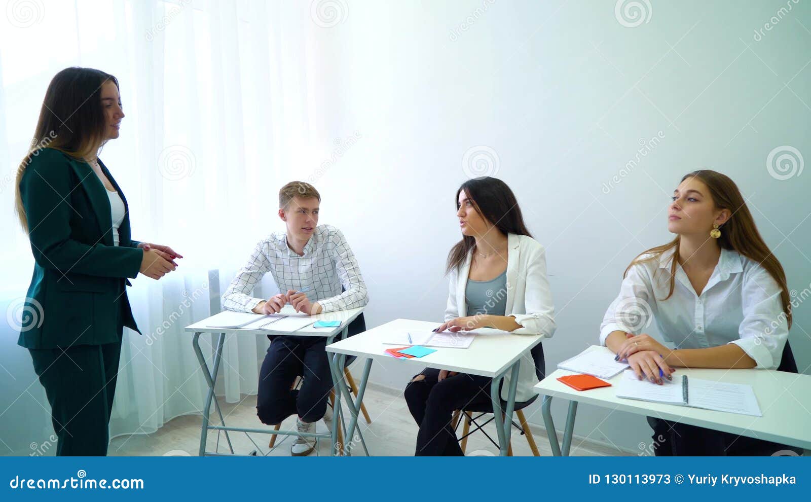 Young Teacher and Students Having Discussion in Classroom Stock Video ...