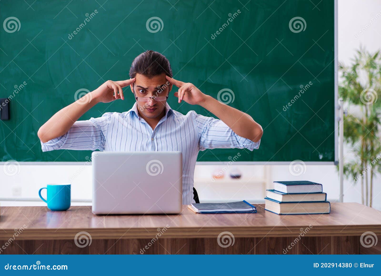 Young Male Teacher in Tele-education Concept in the Classroom Stock ...