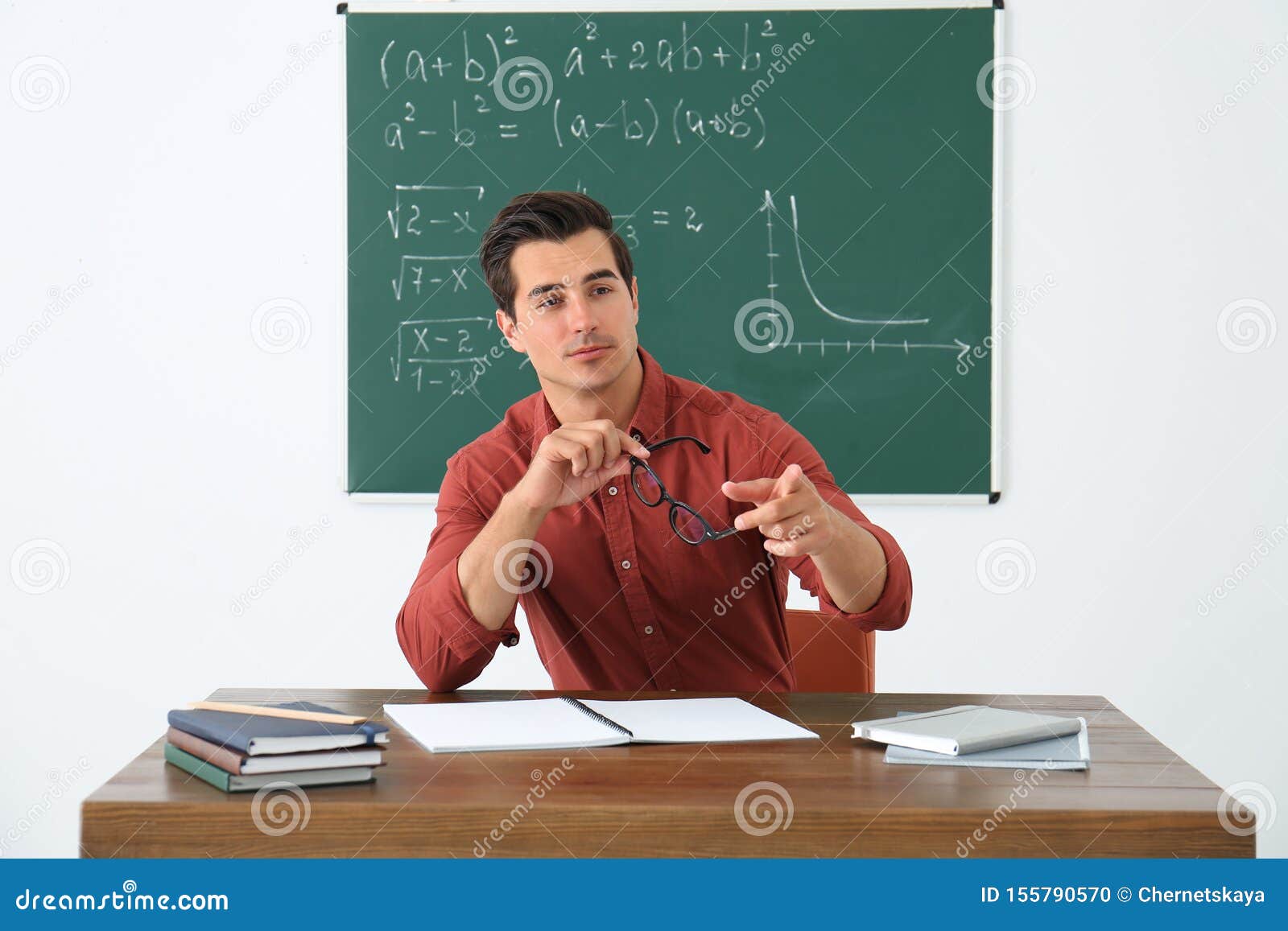 Young Teacher Working at Table in Stock Photo - Image of professor ...