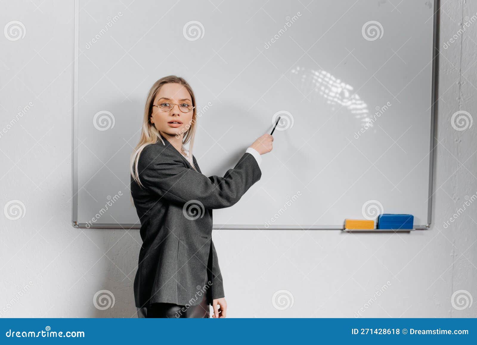 Young Teacher Writes on the Board, Explains Exercises To Students ...
