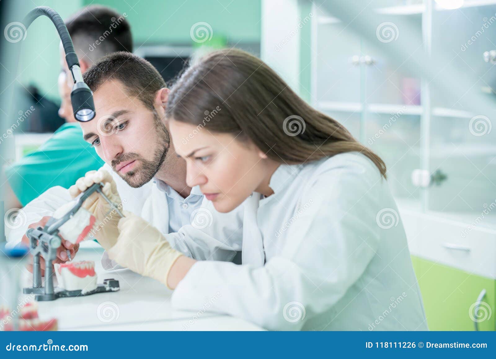 Young Team of Dental Technicians Making Teeth Prostetics. Process of ...