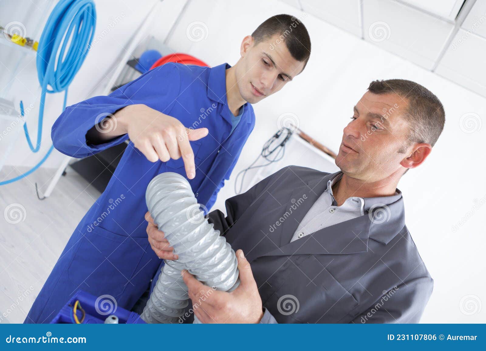 Young Technician Asking Question about Ventilation Hose Stock Photo ...