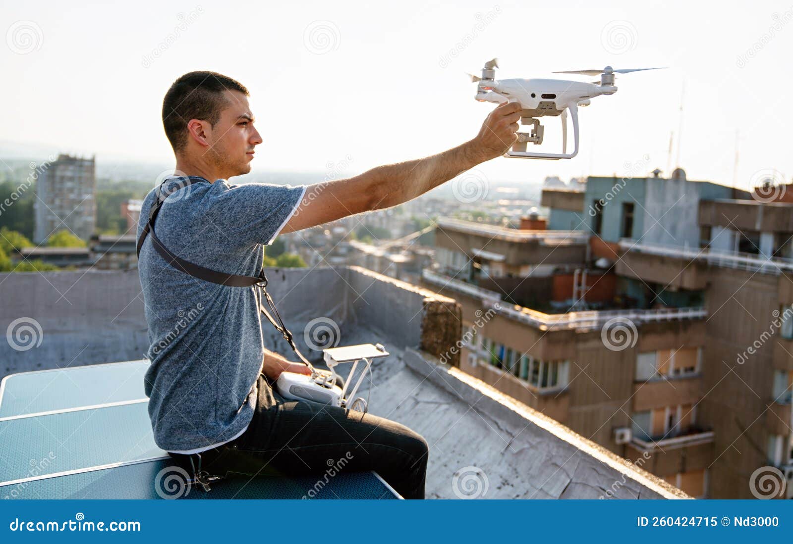 Young Technician Flying UAV Drone with Remote Control on Rooftop Stock ...